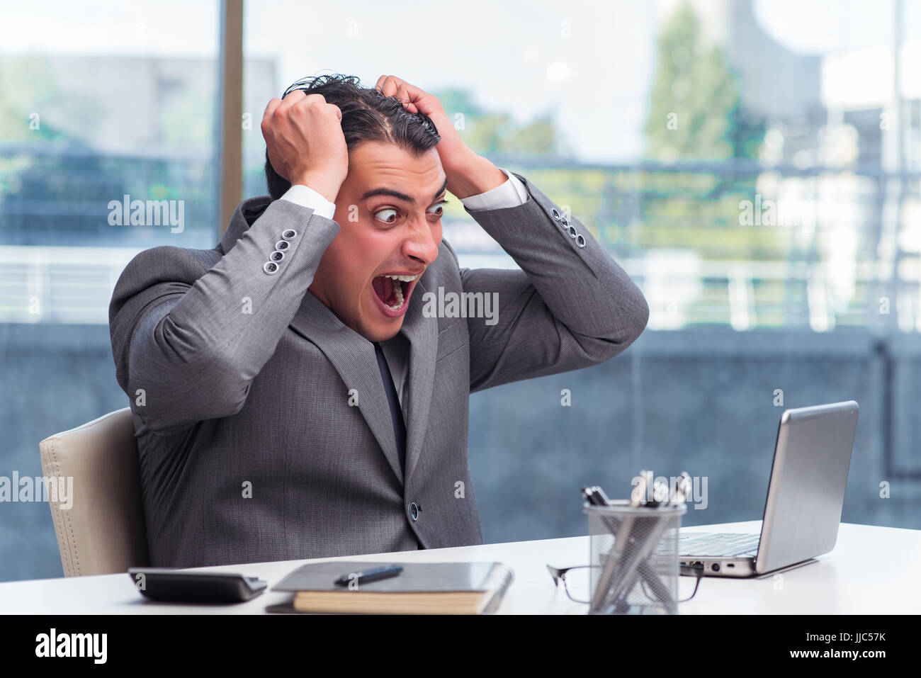 Busy angry businessman with heaps of paper Stock Photo - Alamy