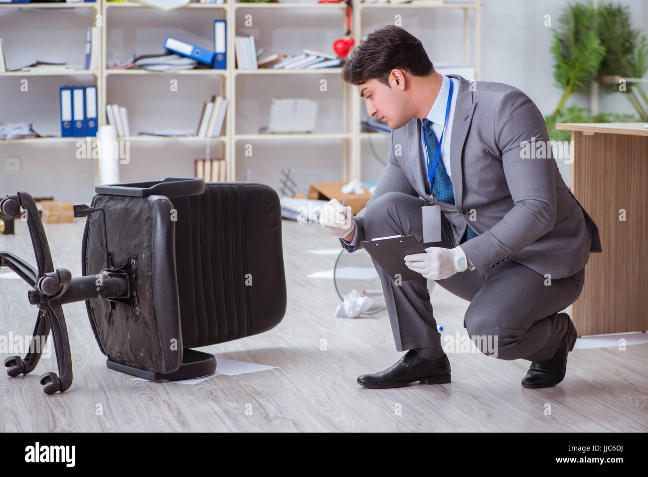 Young man during crime investigation in office Stock Photo - Alamy