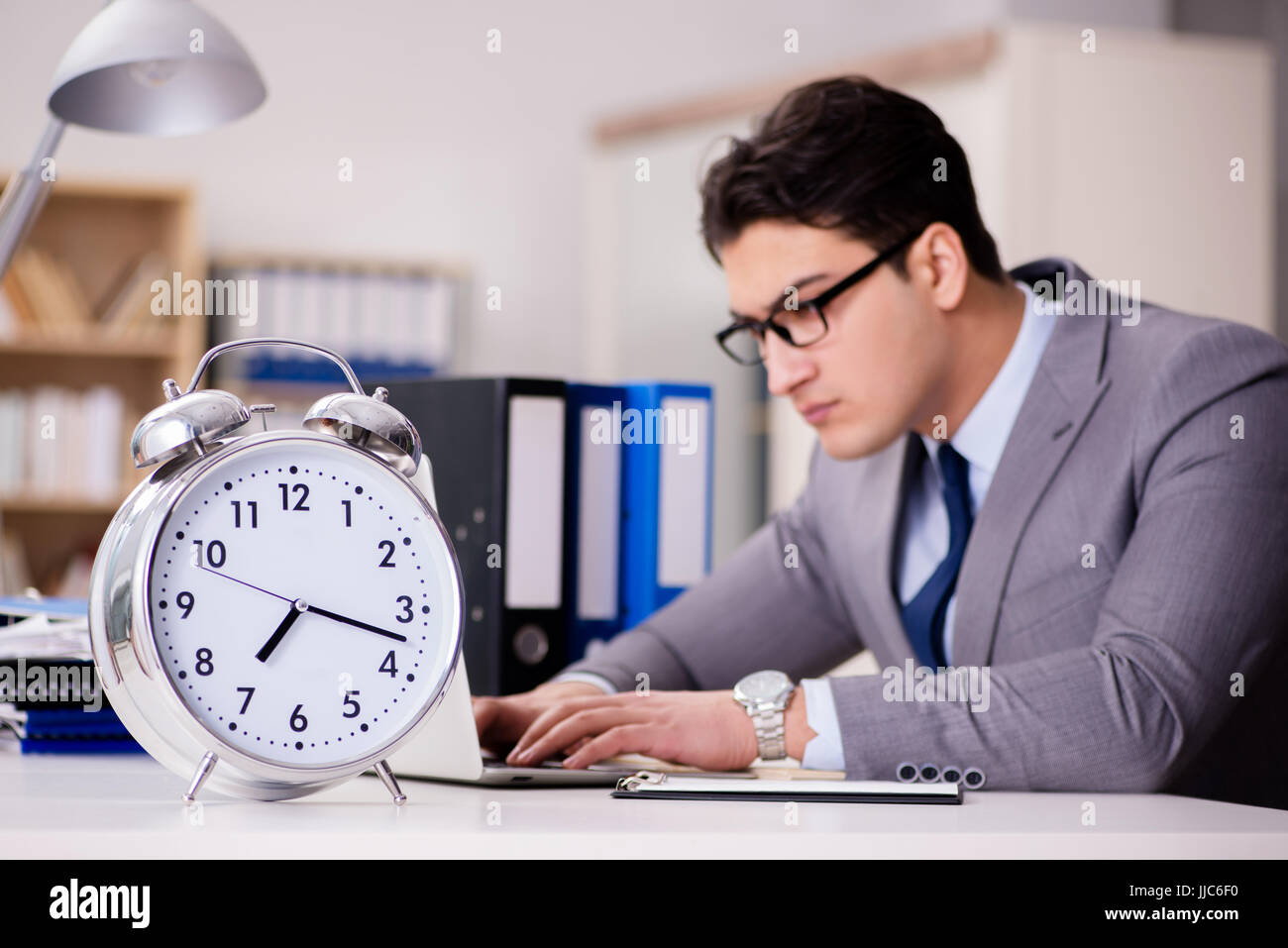 Businessman failing to meet the deadlines Stock Photo - Alamy