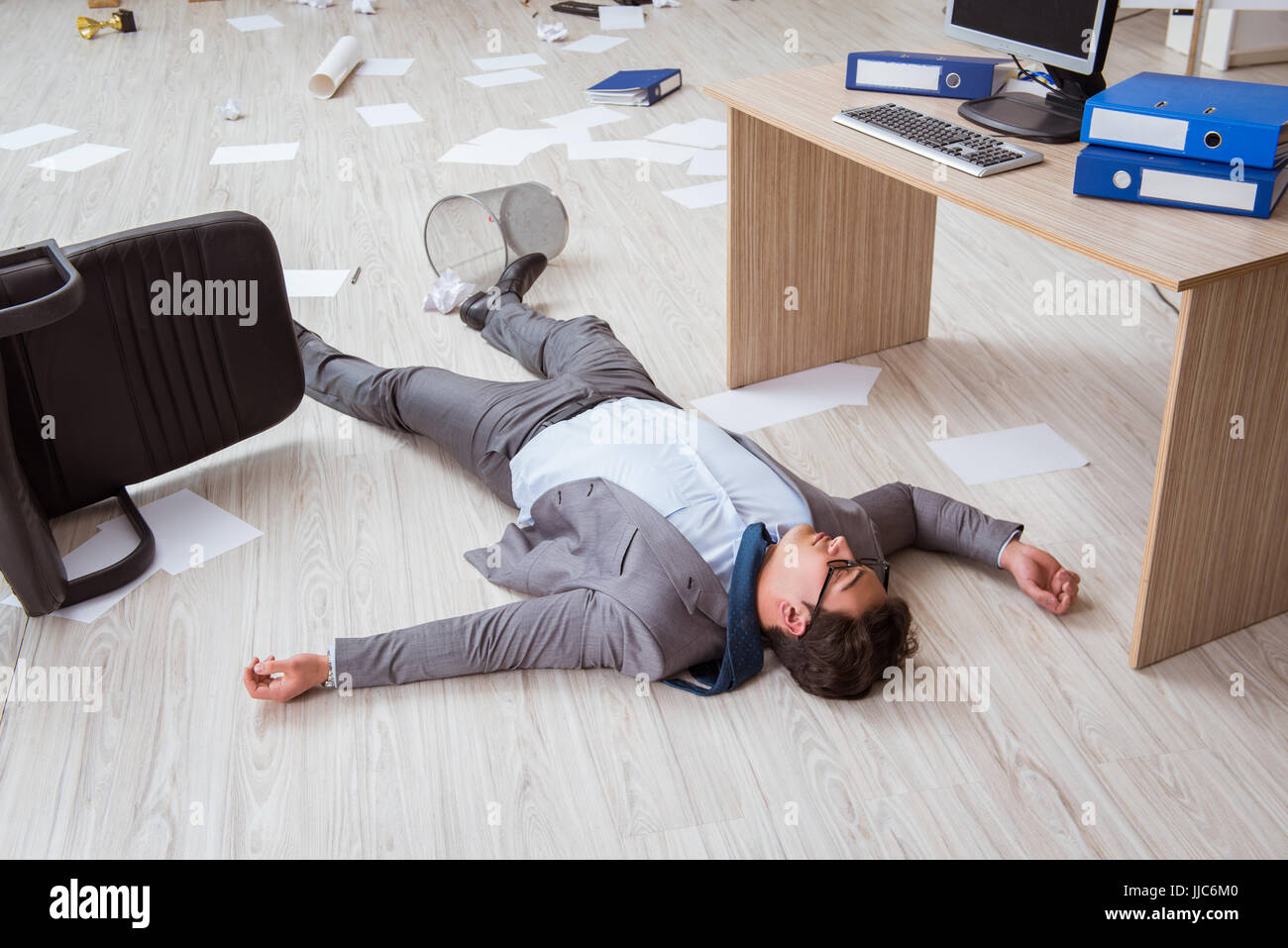 Businessman dead on the office floor Stock Photo - Alamy