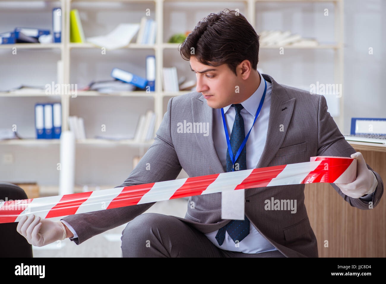 Young man during crime investigation in office Stock Photo - Alamy