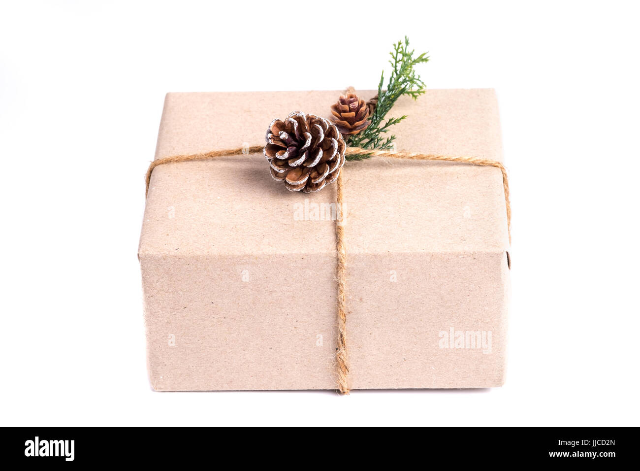 Brown paper craft warped on present box decorate with pine cone and ...