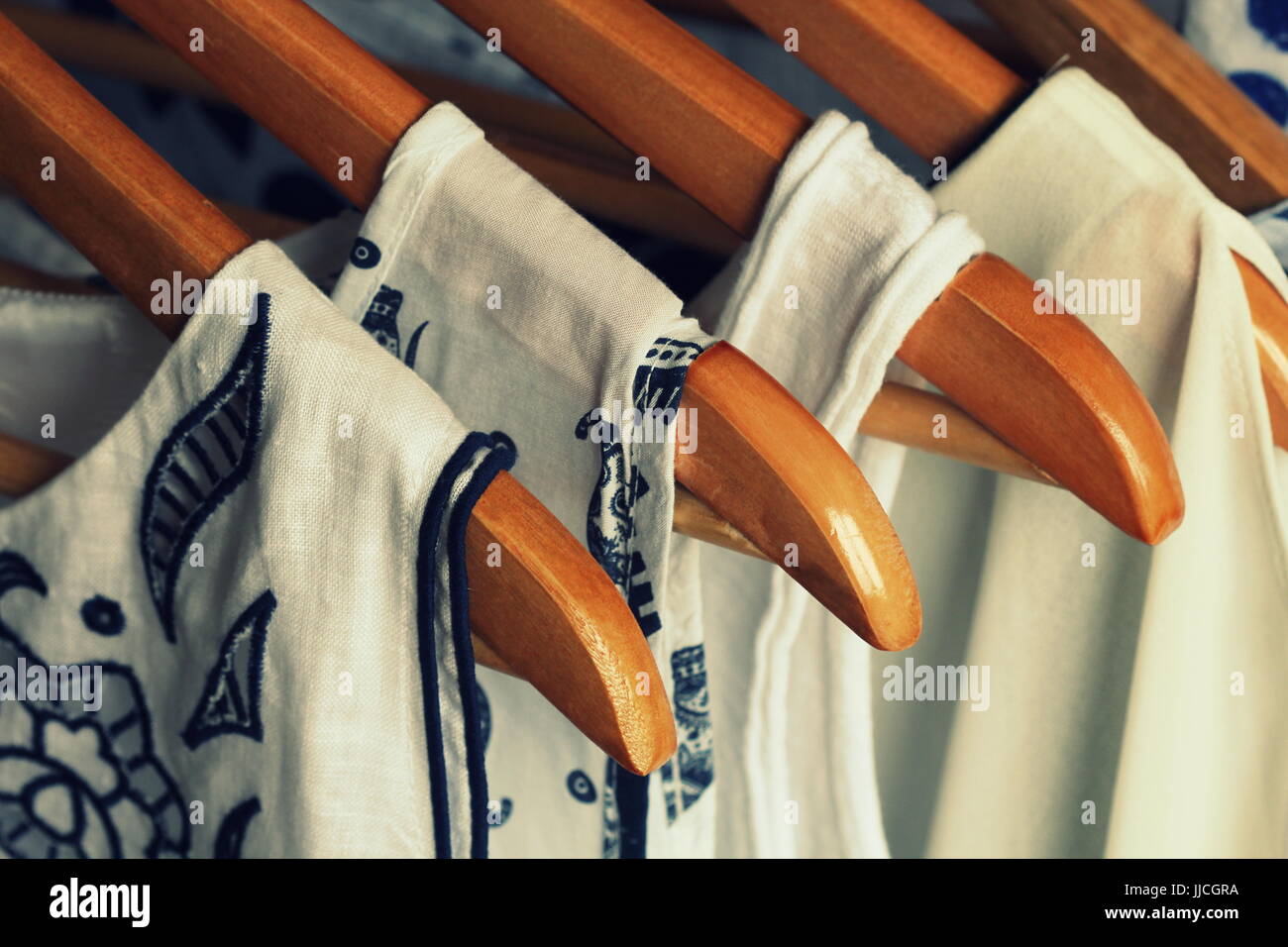 Summer collection of women's clothes hanging on a rack Stock Photo - Alamy