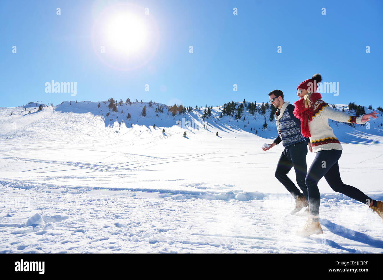 Cheerful young couple having fun in winter park Stock Photo - Alamy