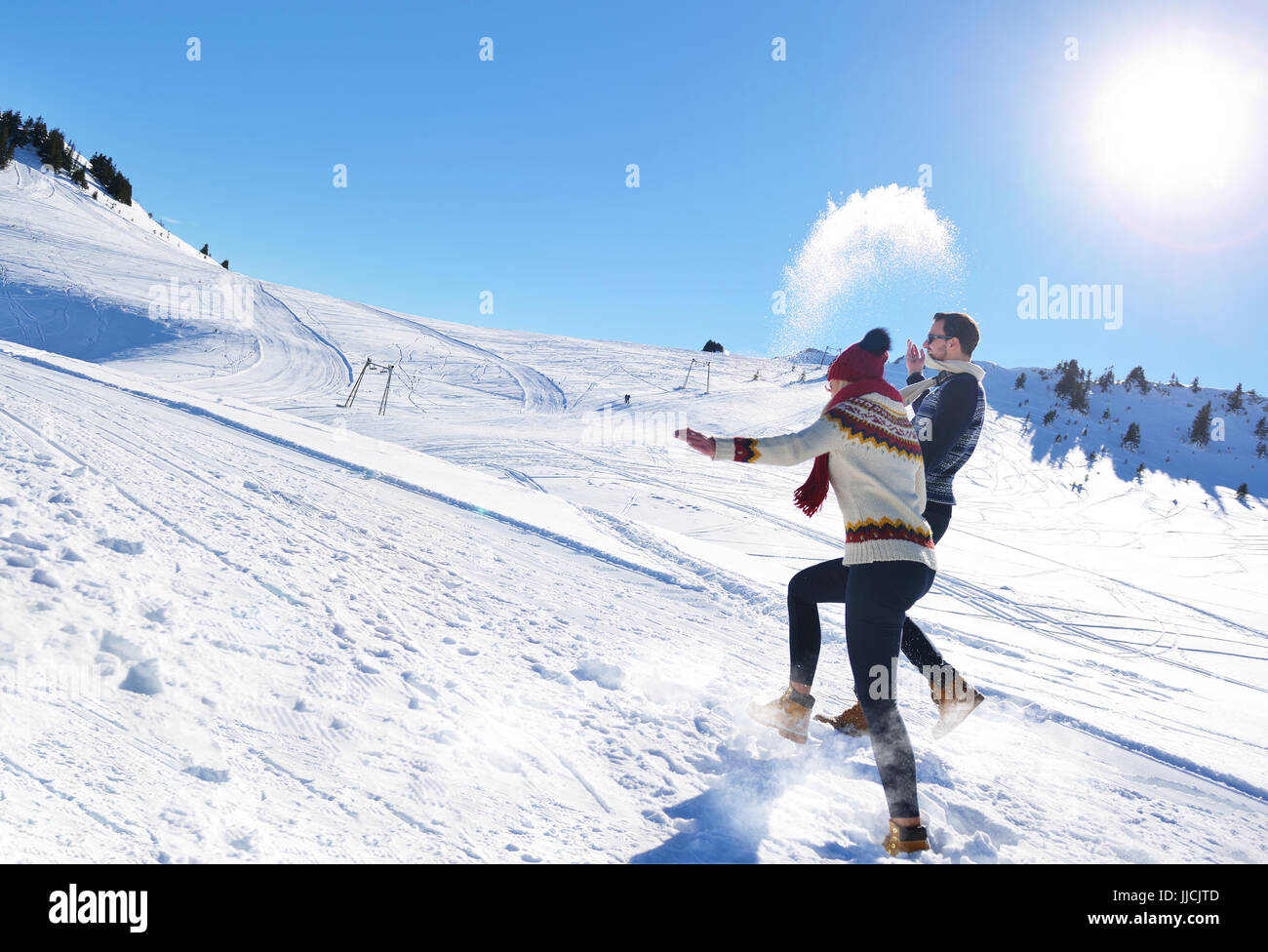 Cheerful young couple having fun in winter park Stock Photo - Alamy