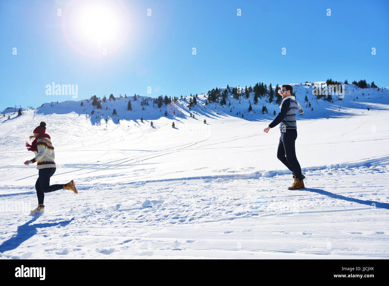 Cheerful young couple having fun in winter park Stock Photo - Alamy