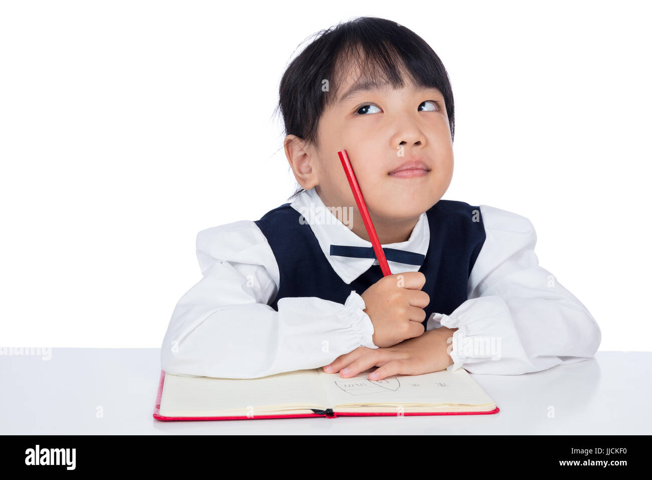 Asian Little Chinese girl writing homework in isolated white background ...