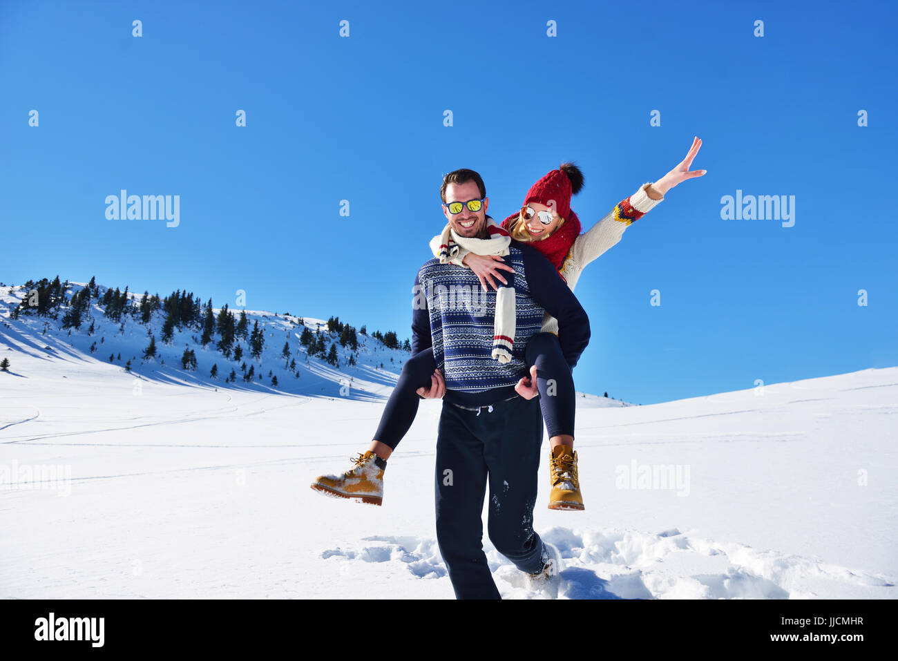 Loving couple playing together in snow outdoor Stock Photo - Alamy