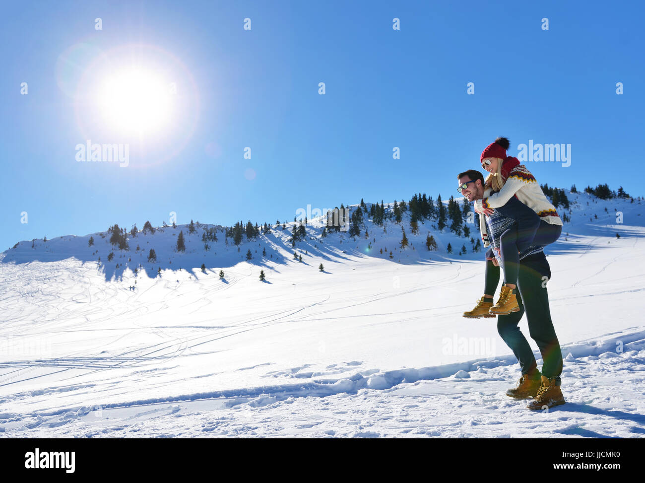 Loving couple playing together in snow outdoor Stock Photo - Alamy