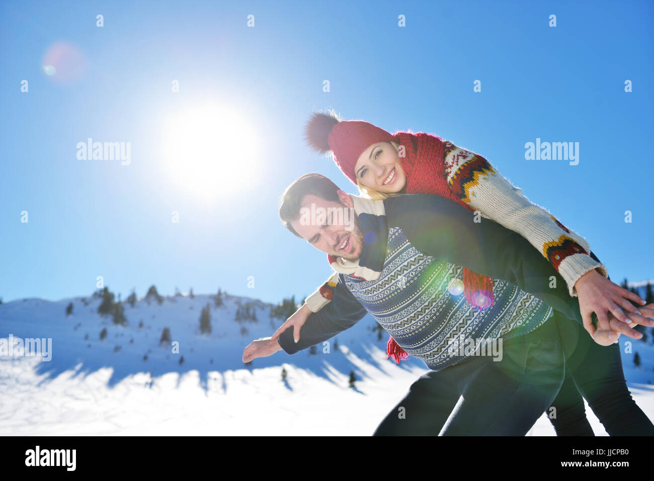 Loving couple playing together in snow outdoor Stock Photo - Alamy