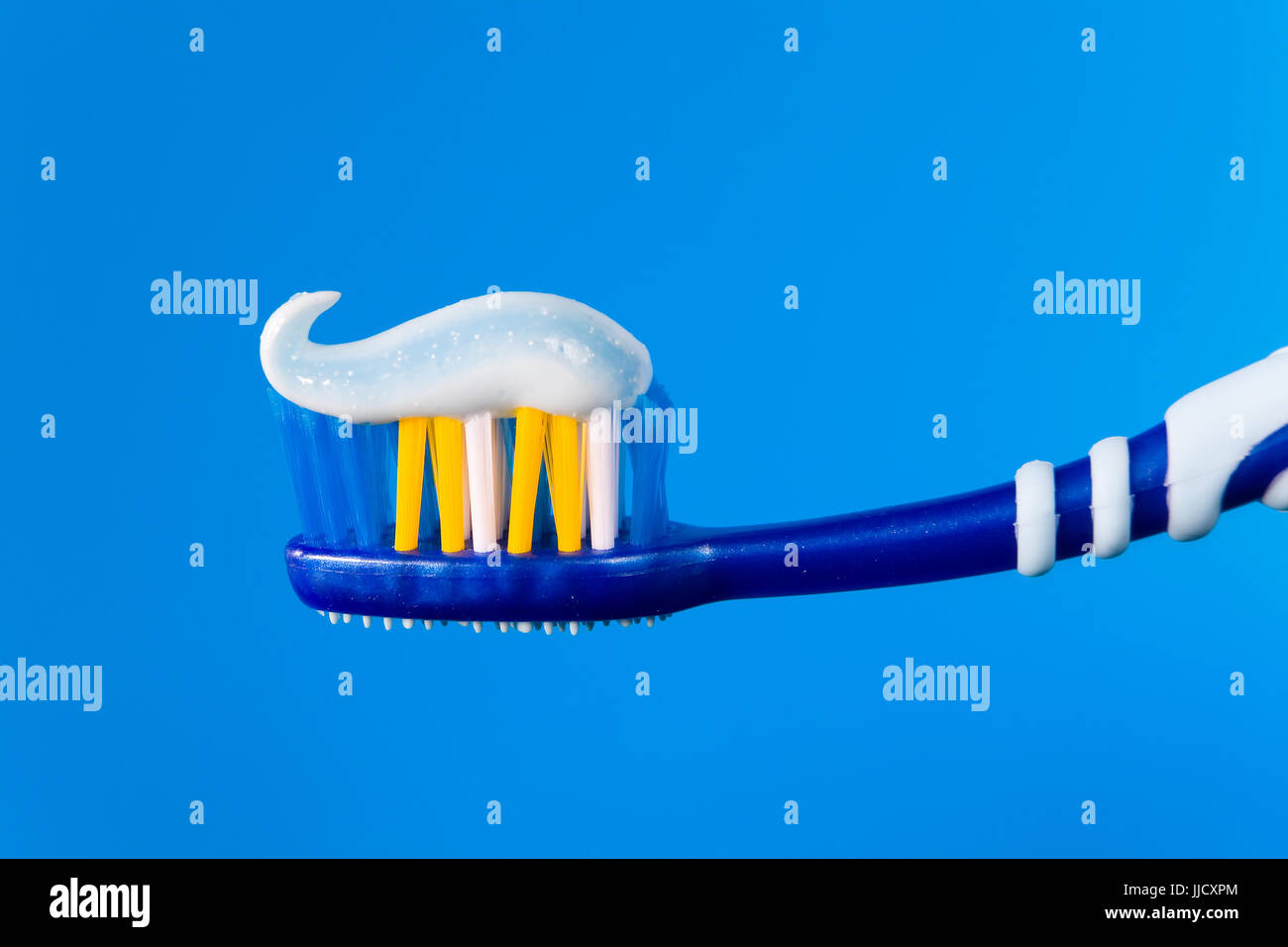 Toothbrush toothpaste blue background hi-res stock photography and ...