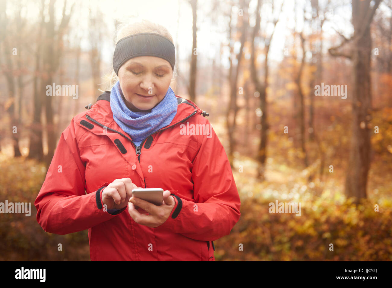 Female runner with cell phone Stock Photo - Alamy