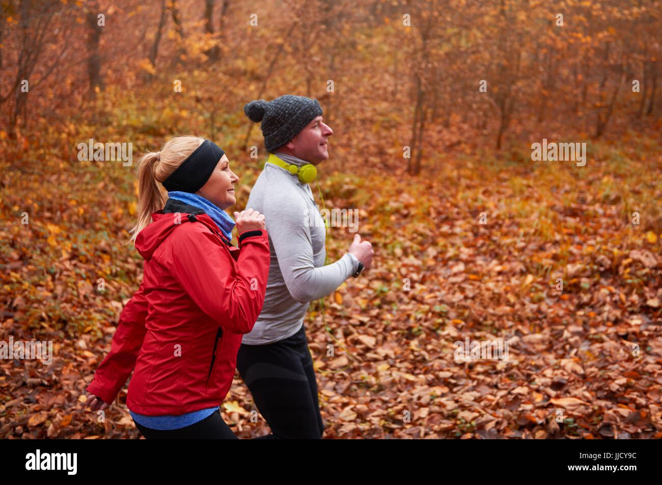 Two older people jogging in the pathway Stock Photo - Alamy