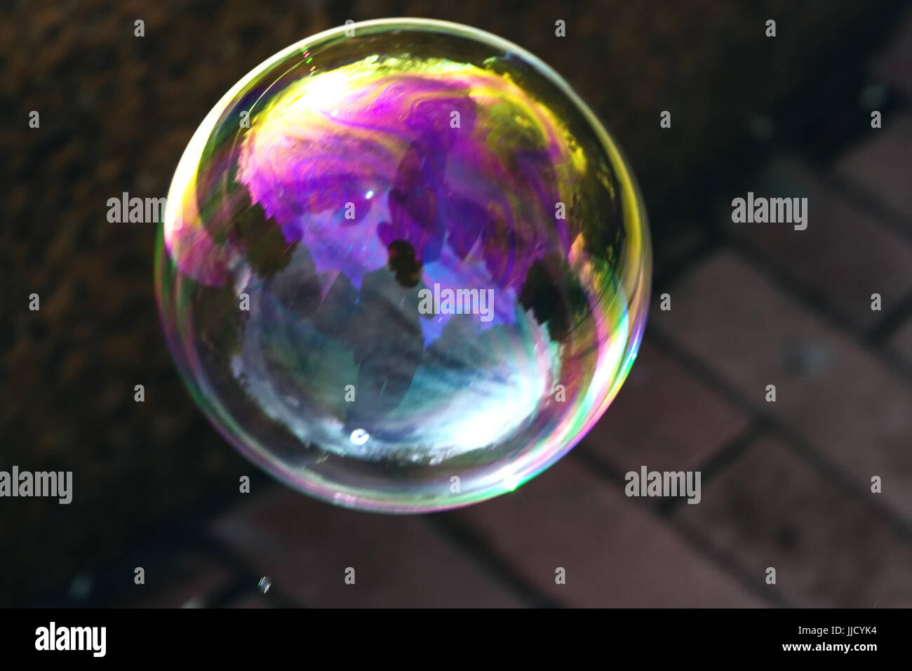 A beautiful soap bubble with reflections and overflows. Close-up Stock ...