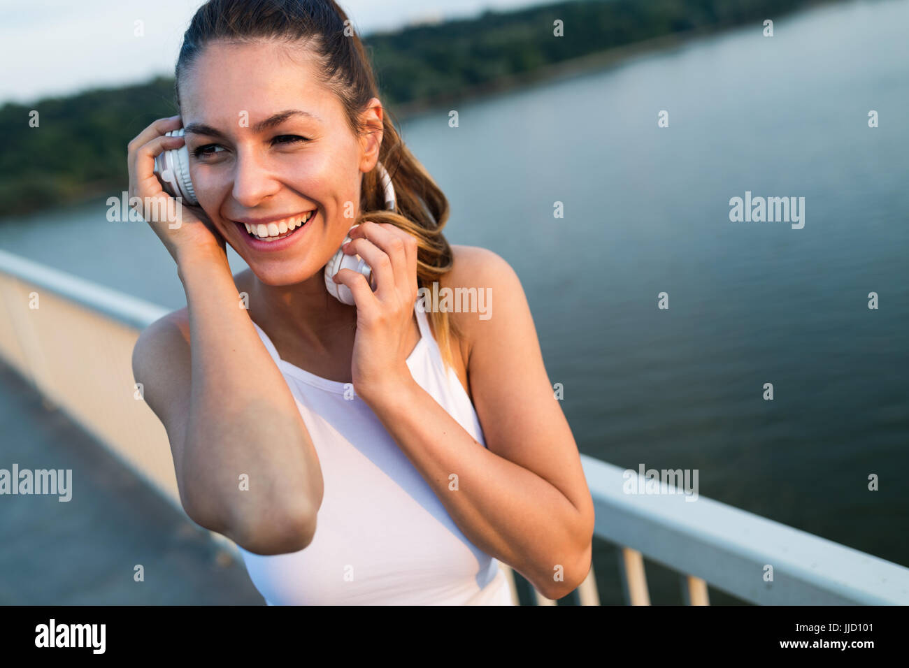 Portrait of woman taking break from jogging Stock Photo - Alamy