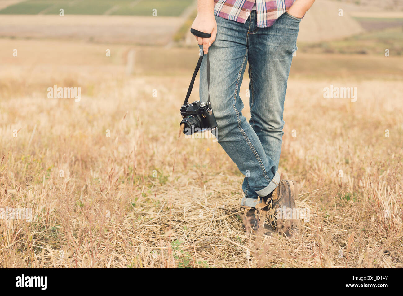 Portrait of attractive male photographer outdoors at sunset. Young man ...
