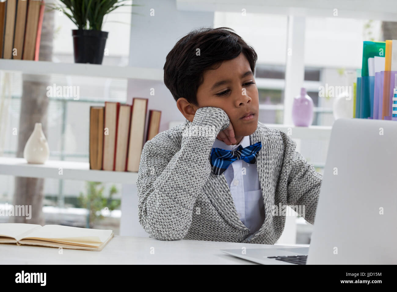 Boredom businessman looking at laptop while working at desk in office ...