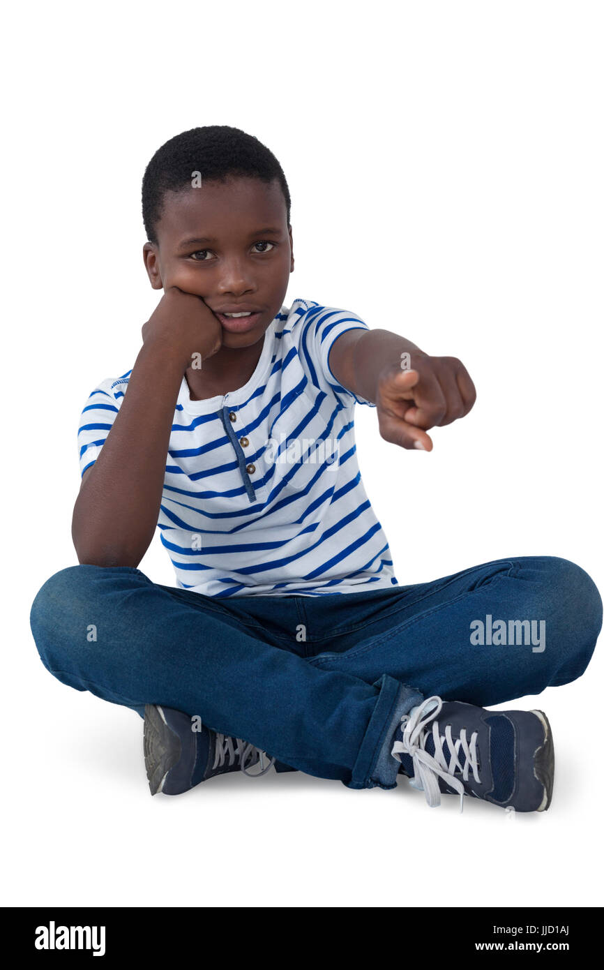 Portrait of sad boy pointing his finger against white background Stock ...