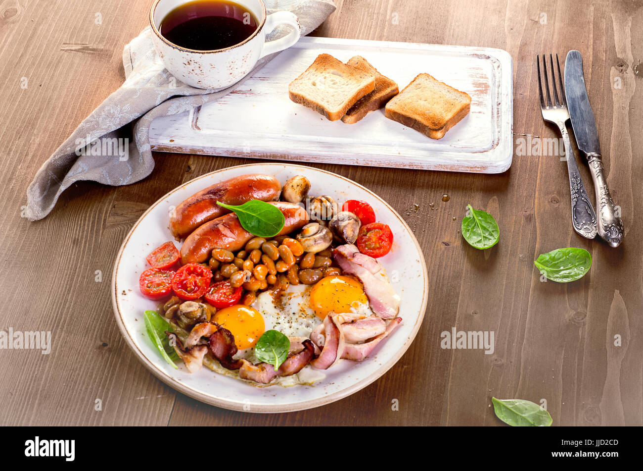 Full english breakfast with fried egg, beans, tomatoes, mushrooms ...