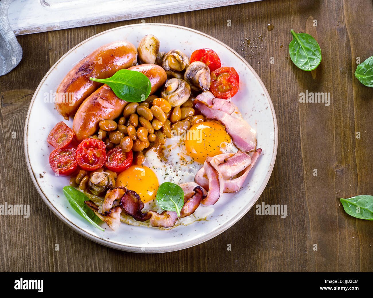 Full english breakfast with fried egg, beans, tomatoes, mushrooms ...