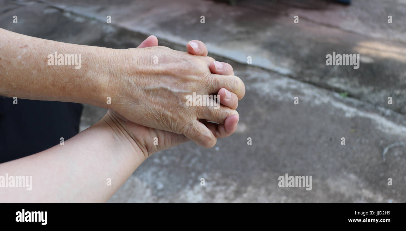 hand in hand,hand in cheerful meaning Stock Photo - Alamy