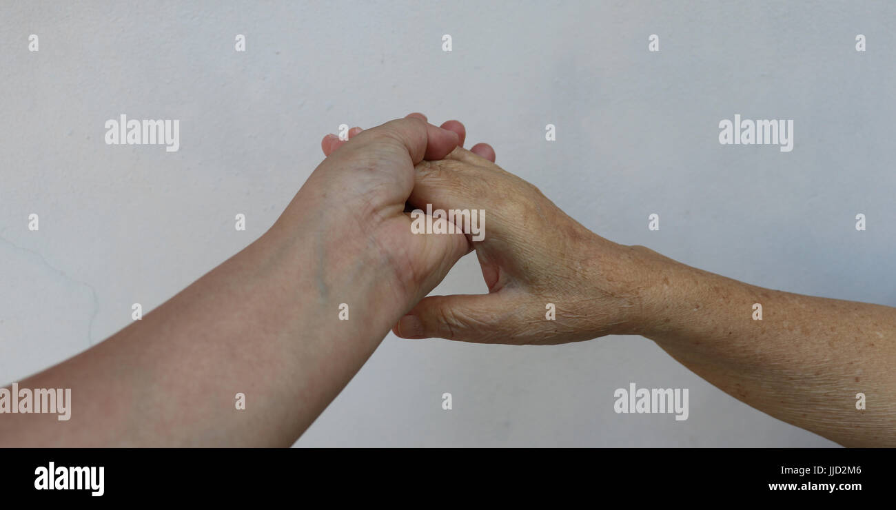 hand in hand,hand in helping meaning,senior Stock Photo - Alamy