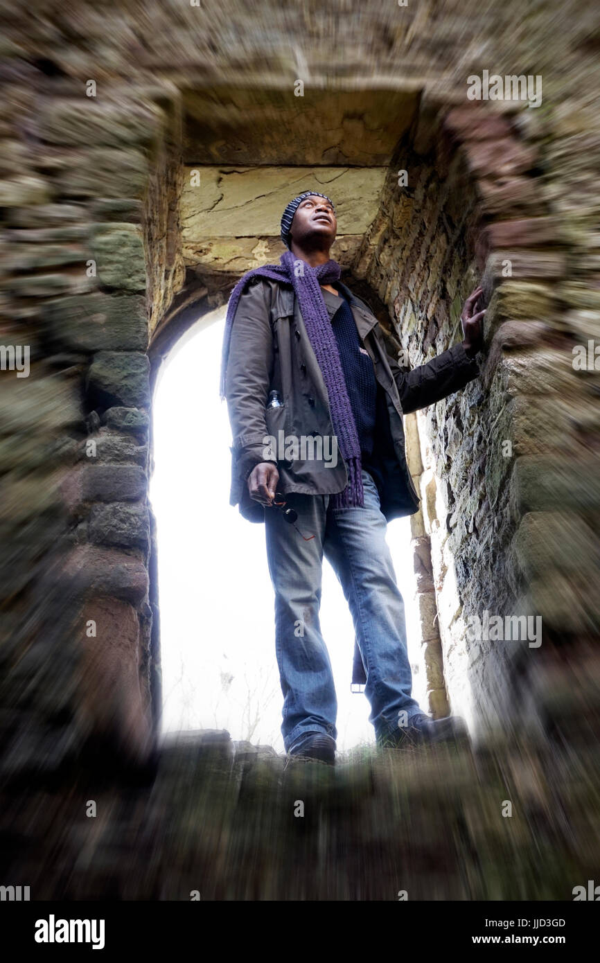 young man standing in ruined window Stock Photo - Alamy