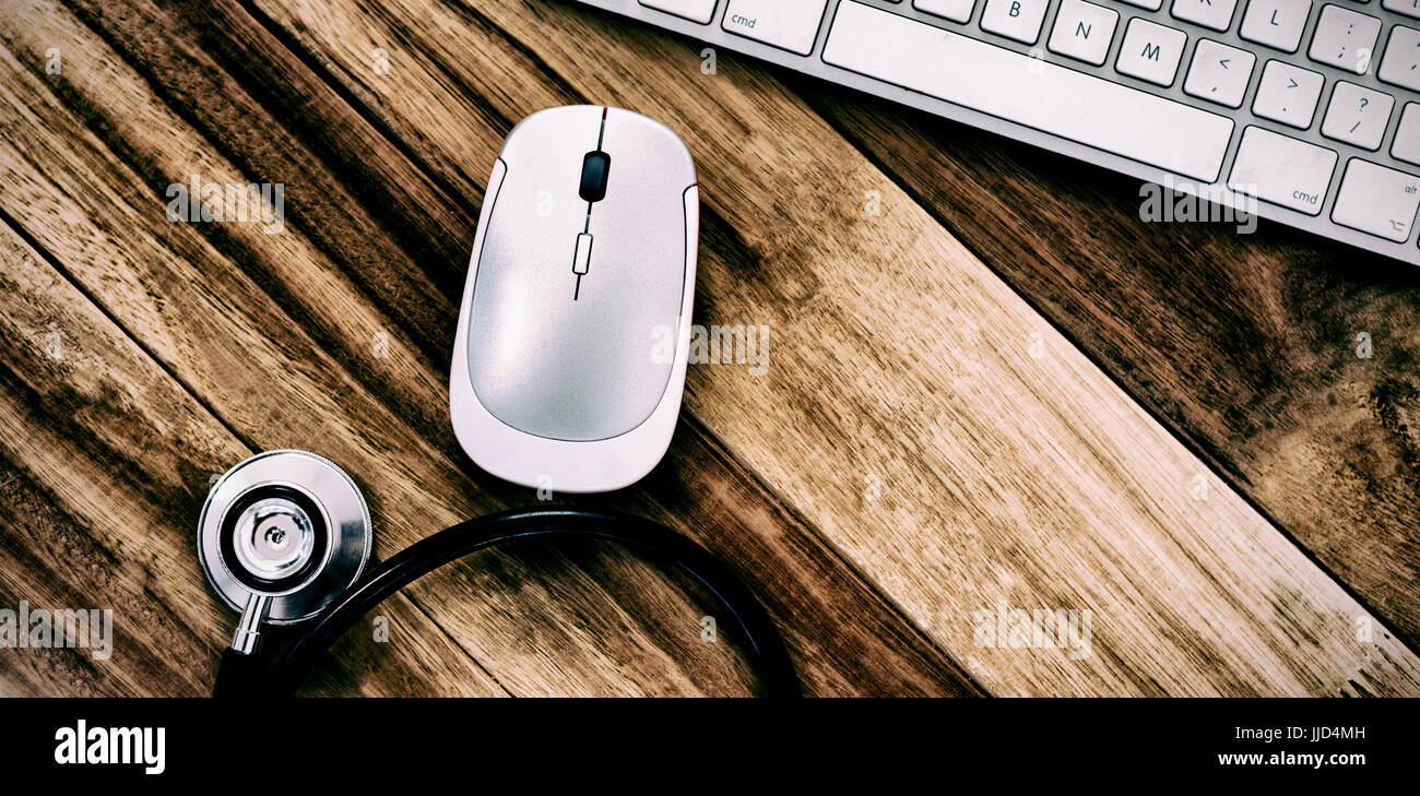 Overhead view of wireless computer mouse and keyboard with stethoscope ...