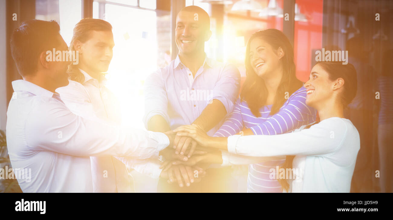 Team of businesspeople forming handstack in office Stock Photo - Alamy