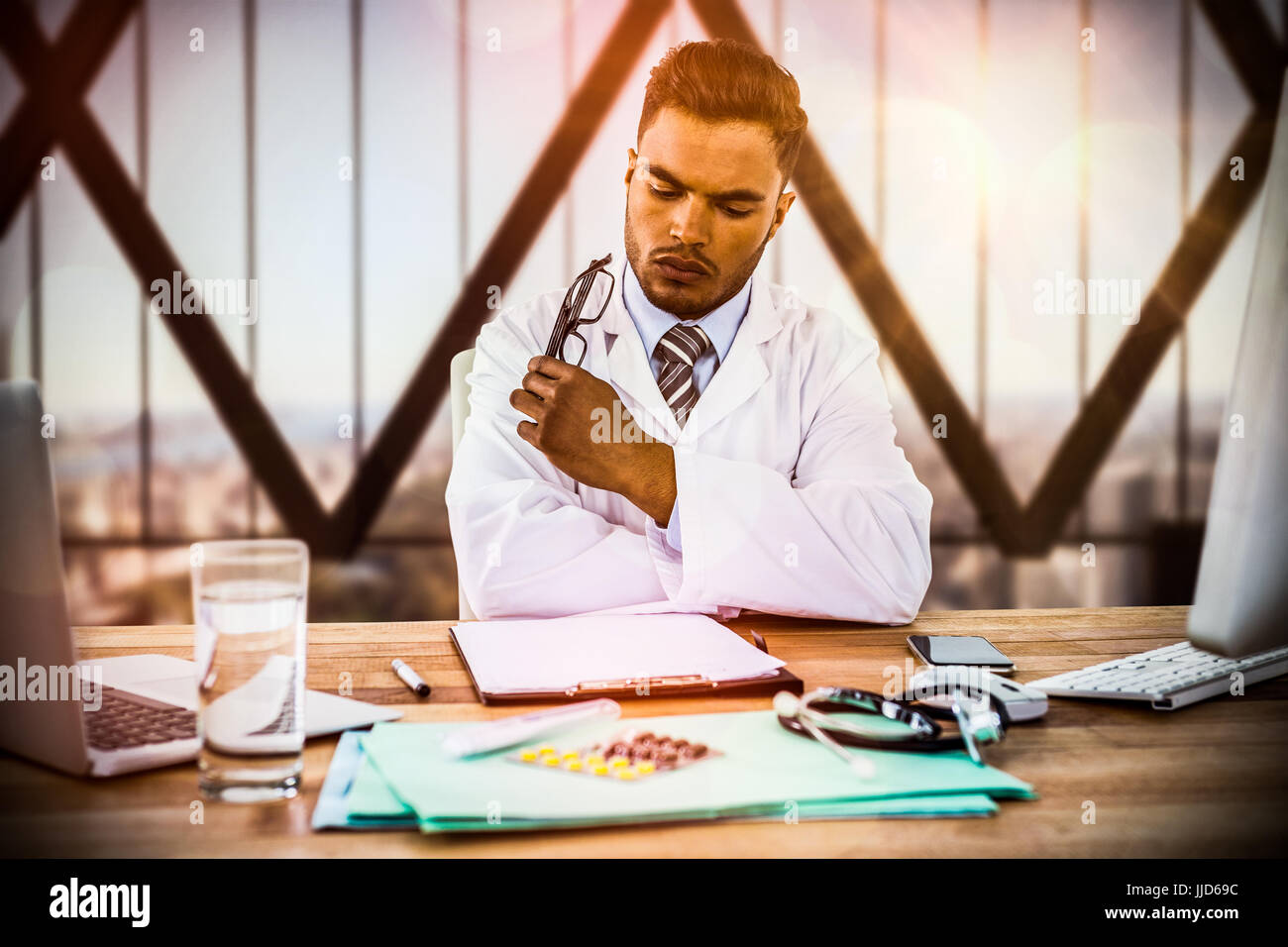 Doctor looking medical report at desk against aerial view of new york ...