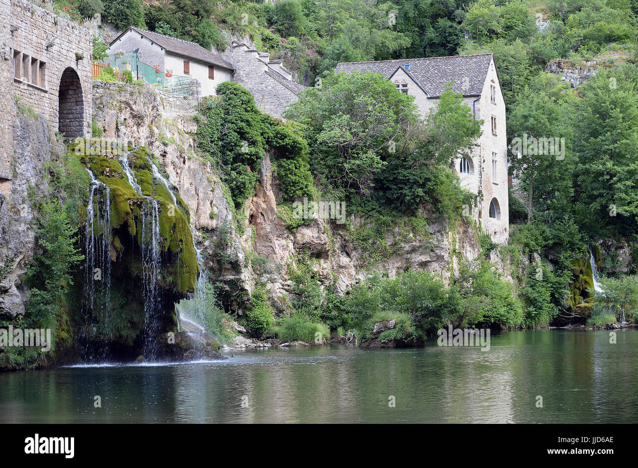 France, Lozere 48, St Chely du Tarn, Waterfall and village buildings in ...