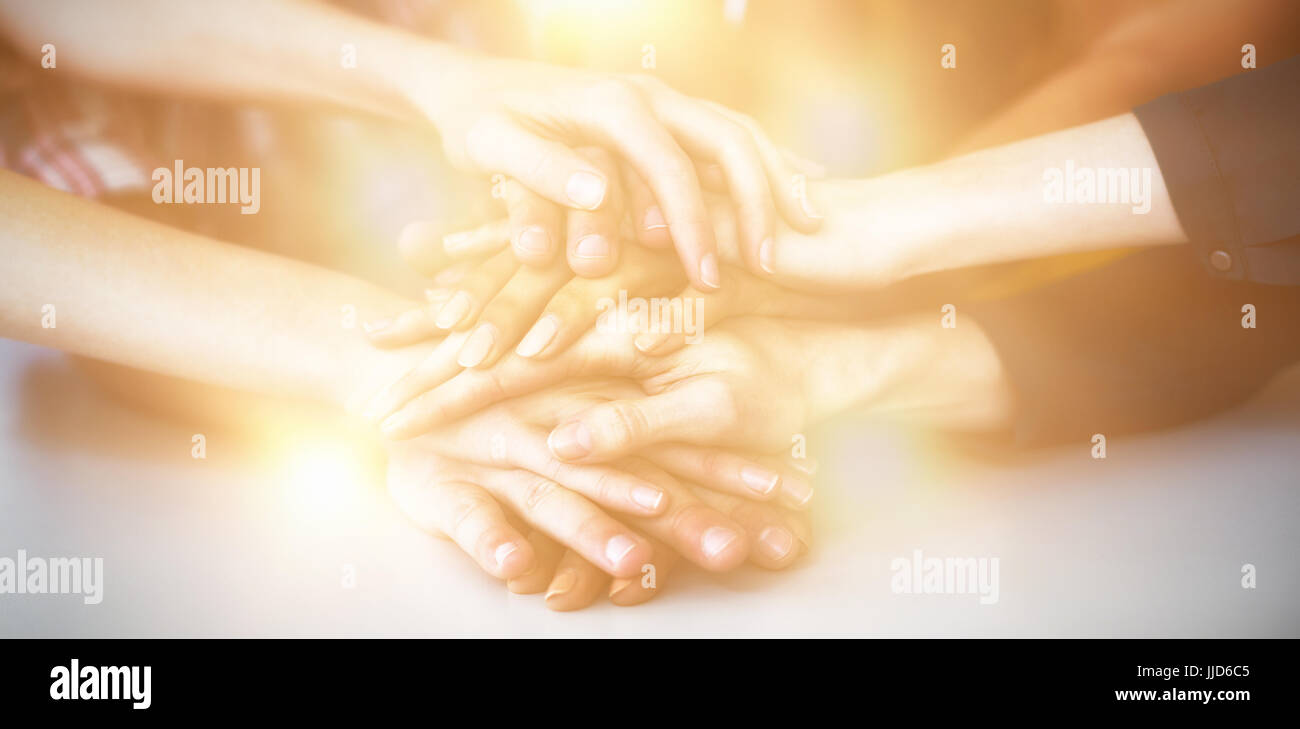 Mid section of business executives forming hand stack in office Stock ...