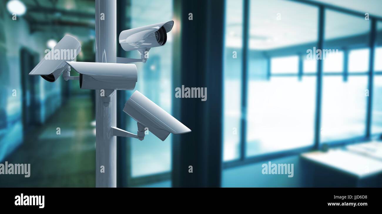 CCTV camera against view of office corridor and workspace Stock Photo ...