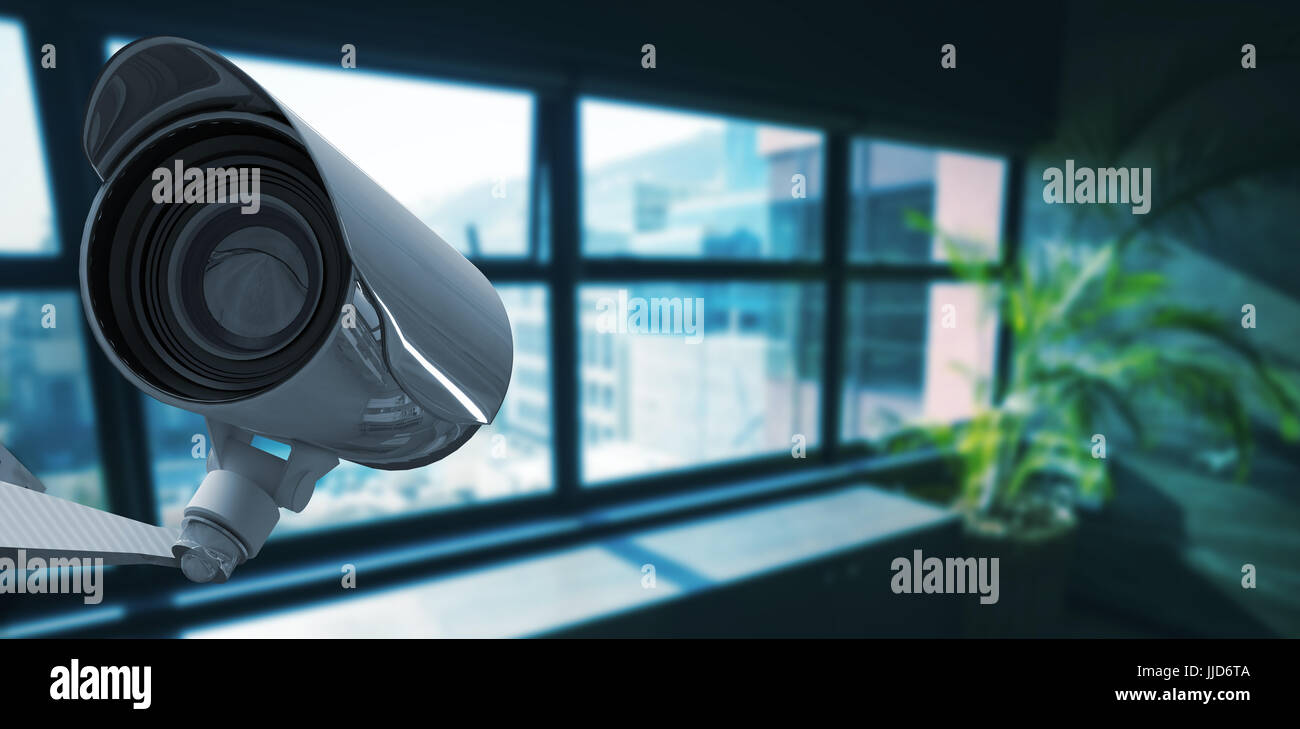 CCTV camera against view of modern buildings through office window ...