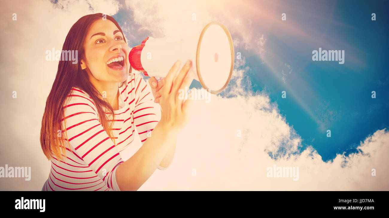 Young woman shouting with megaphone against low angle view of sky Stock ...