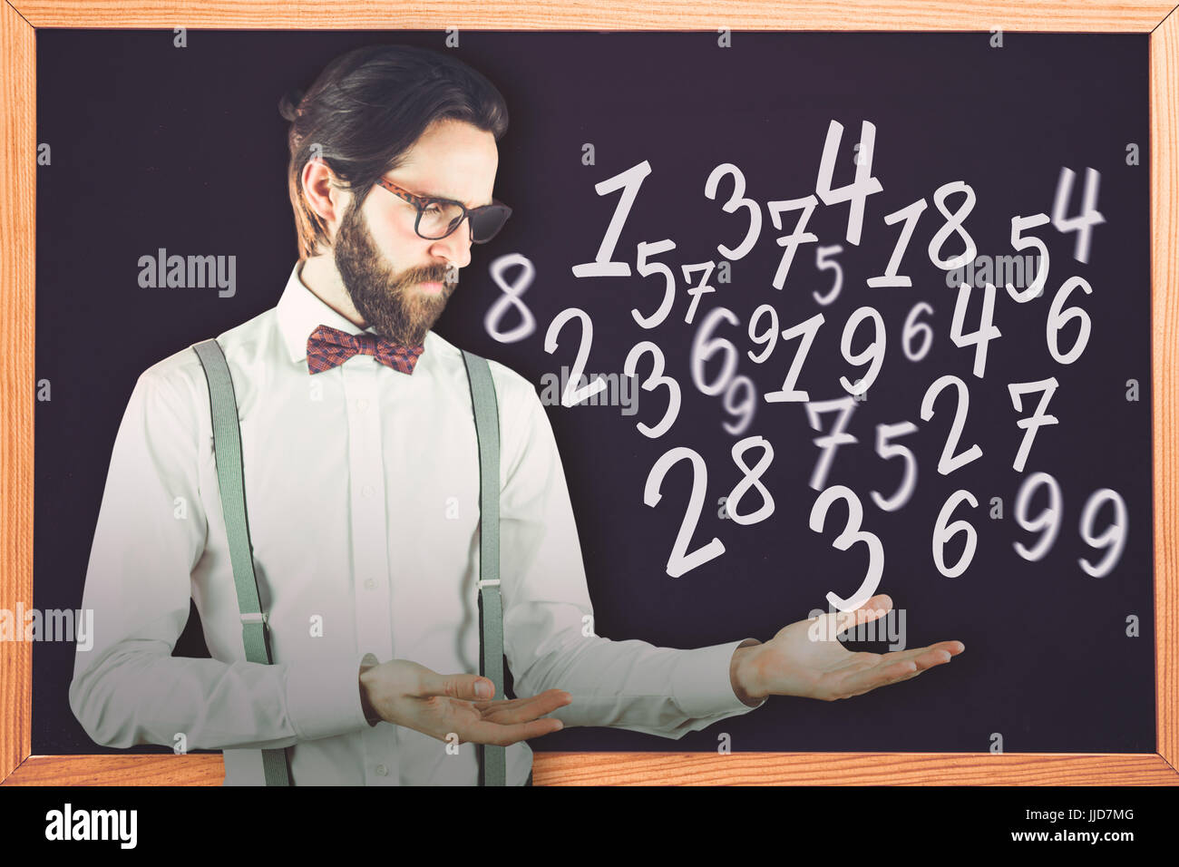 Thoughtful man holding invisible object against numbers Stock Photo - Alamy