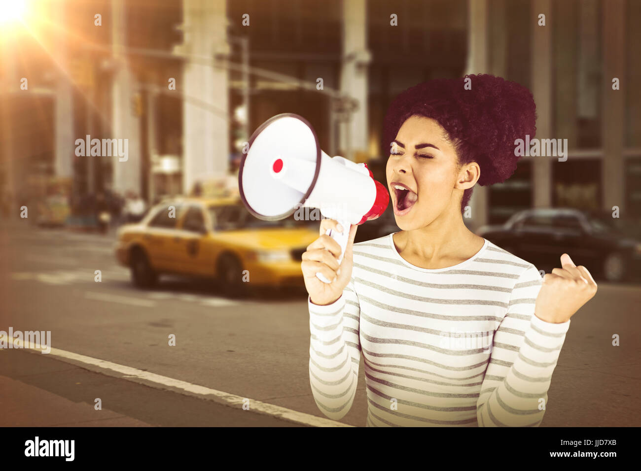 Excited woman shouting with megaphone against picture of a city Stock ...
