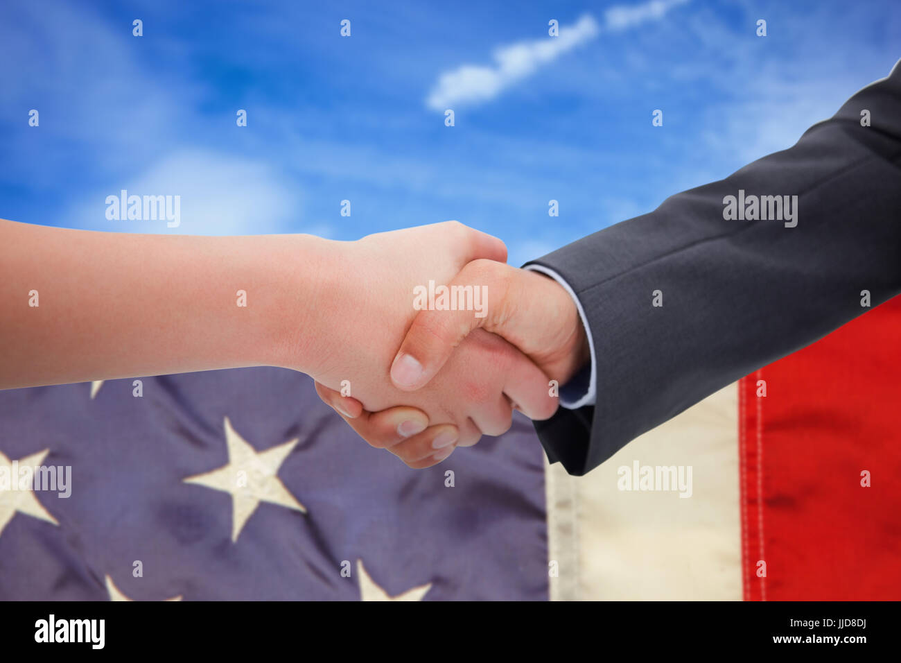 Close up of a handshake against low angle view of cloudy sky Stock ...