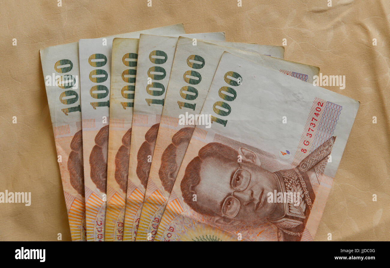 Thai Bath banknotes (1000 bath) on textile background - close up Stock ...