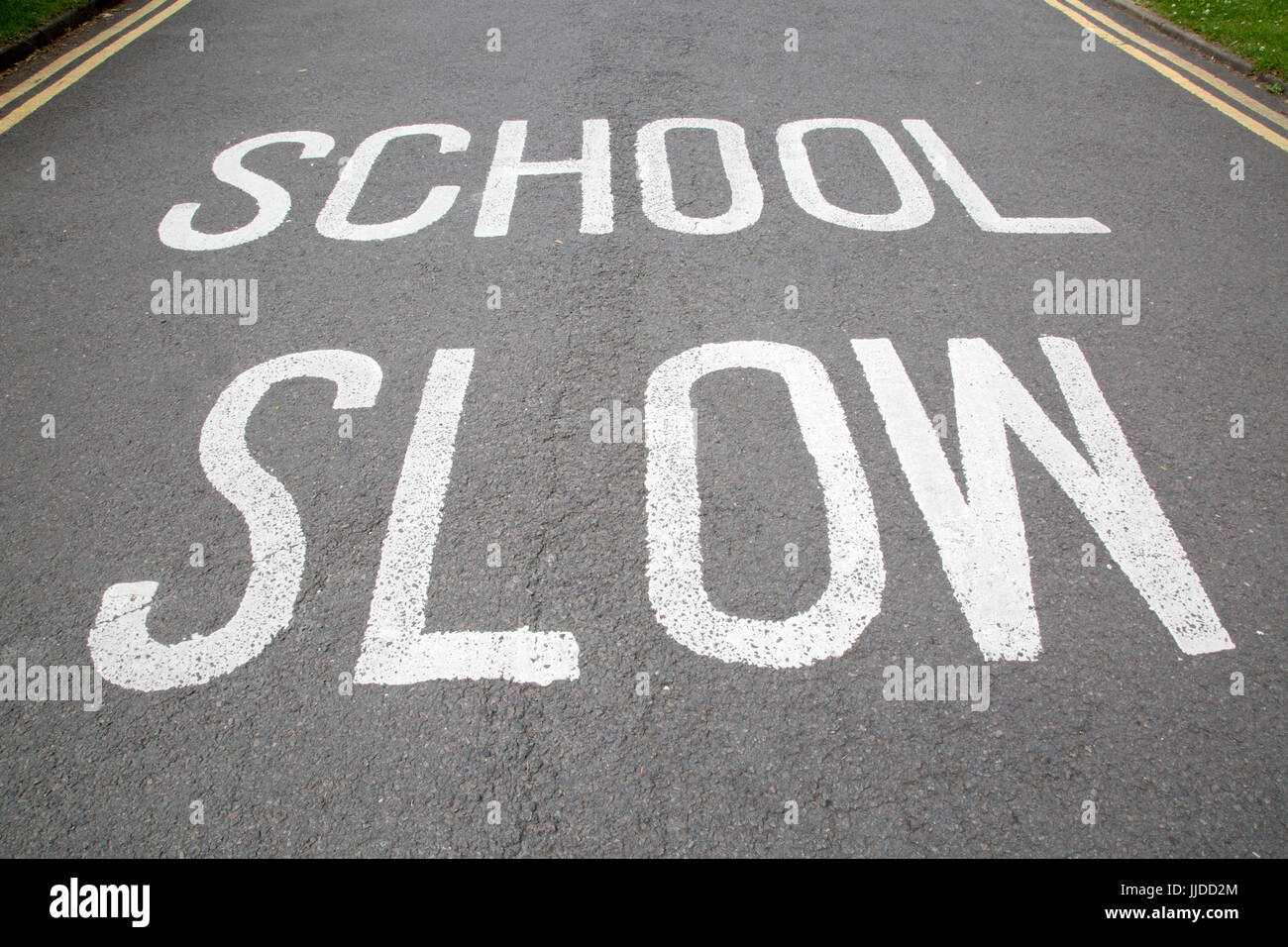School Slow Traffic Warning Sign on Road Surface Stock Photo - Alamy