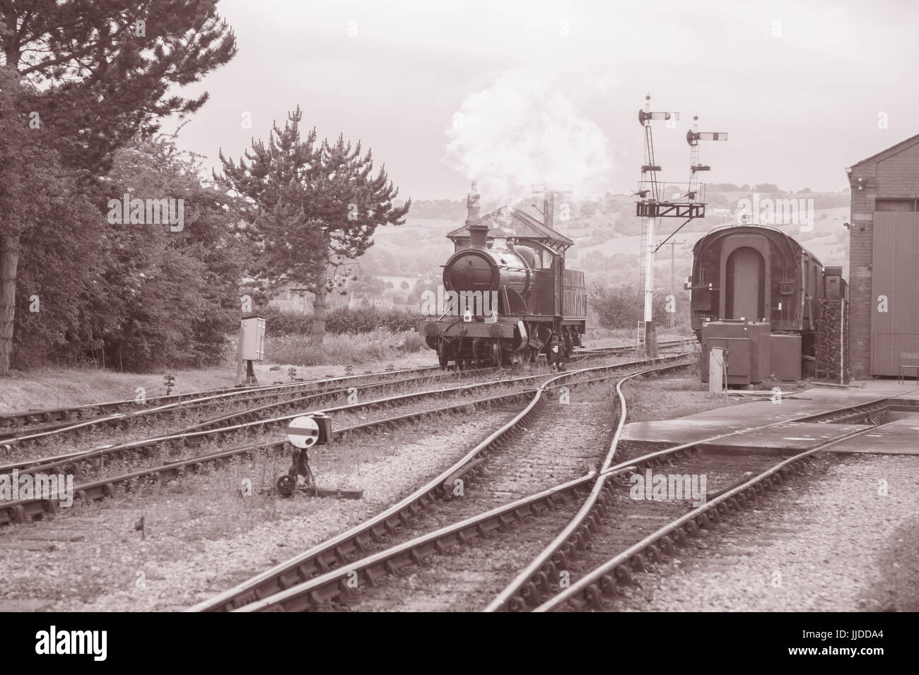 Steam Train on Railway Tracks in Black and White Sepia Tone Stock Photo ...
