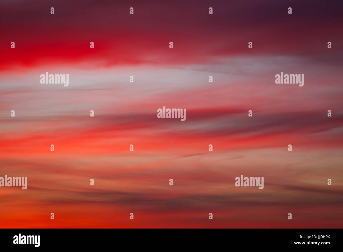 Sunset vivid red clouds background texture Stock Photo - Alamy
