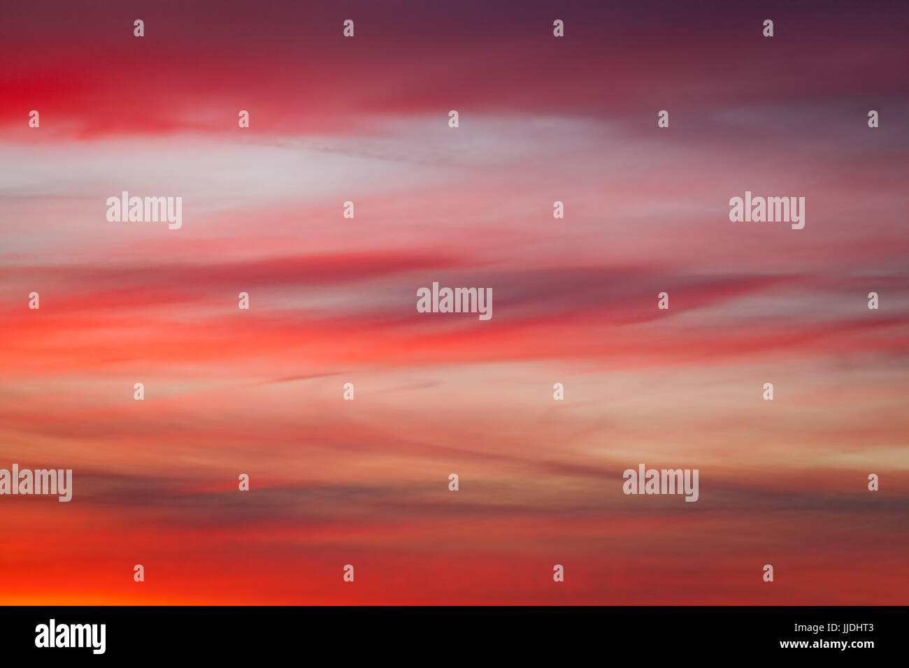 Sunset vivid red clouds background texture Stock Photo - Alamy