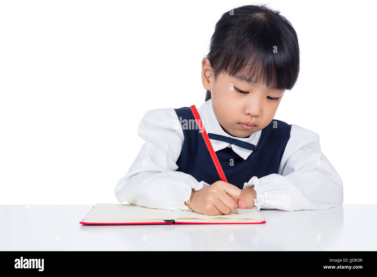 Asian Little Chinese girl writing homework in isolated white background ...