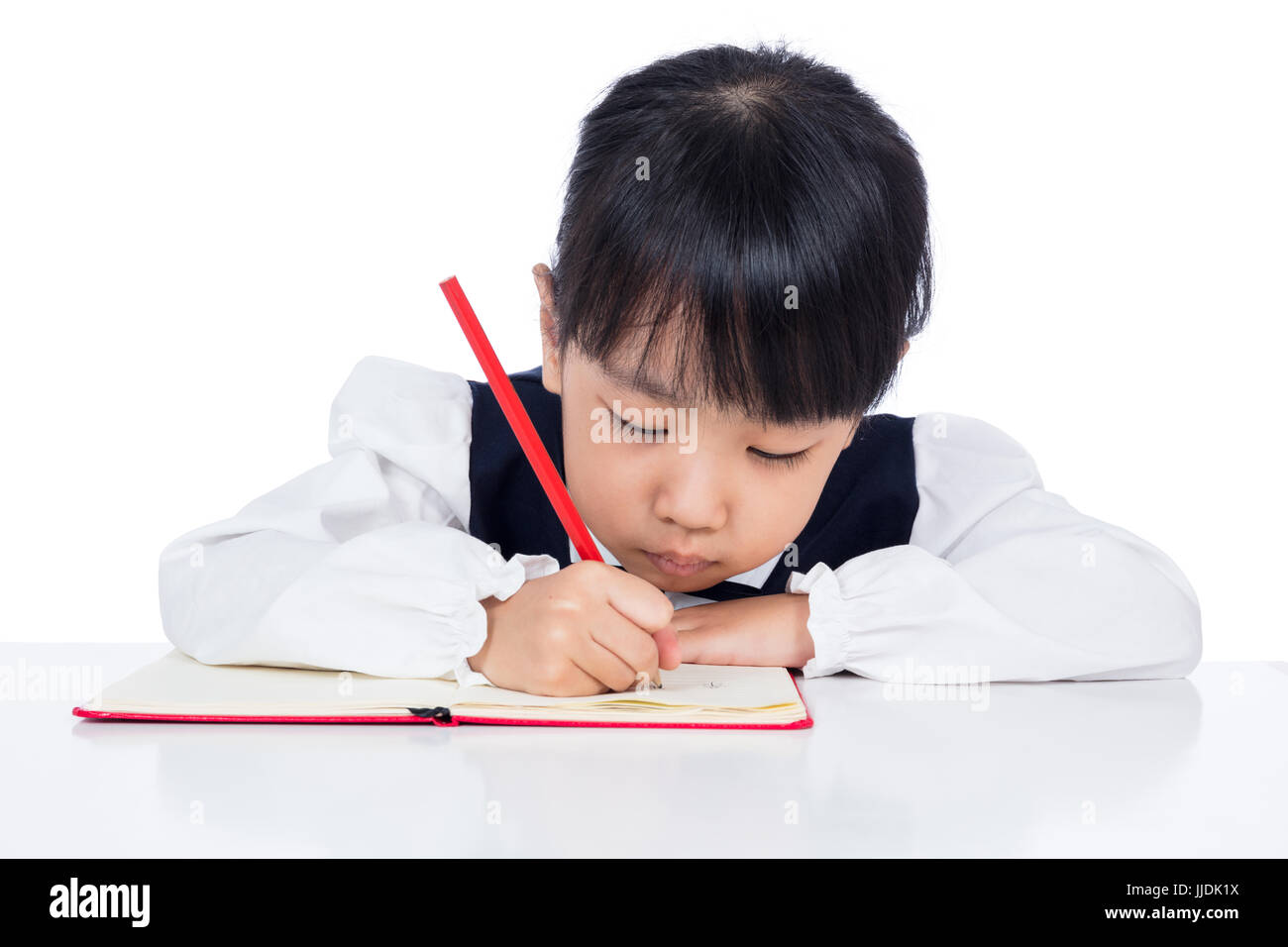 Asian Little Chinese girl writing homework in isolated white background ...