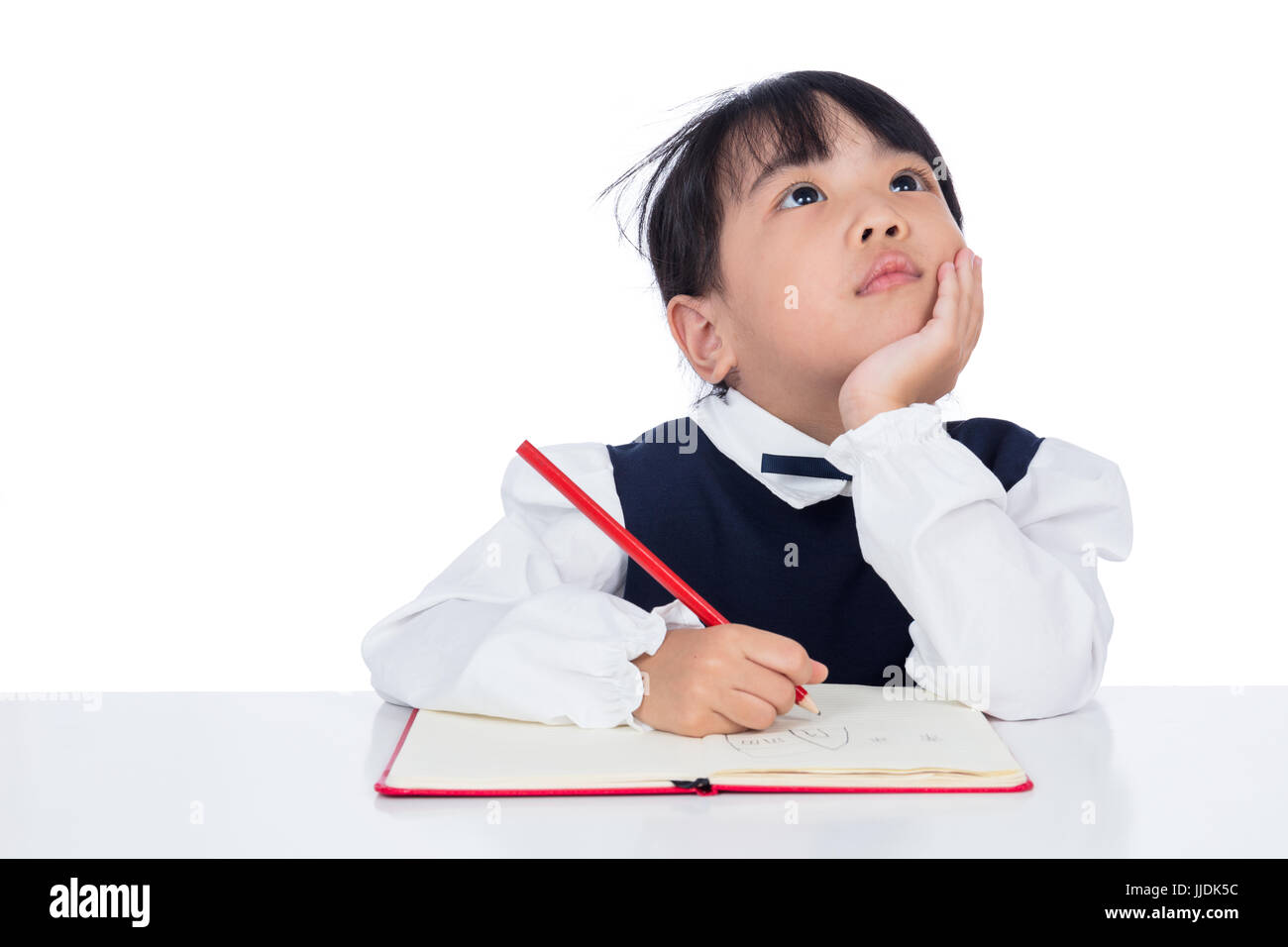 Asian Little Chinese girl writing homework in isolated white background ...