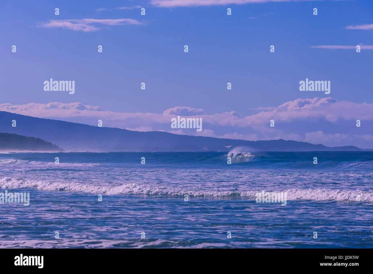 Strong ocean waves and hills at the background with copy space Stock ...