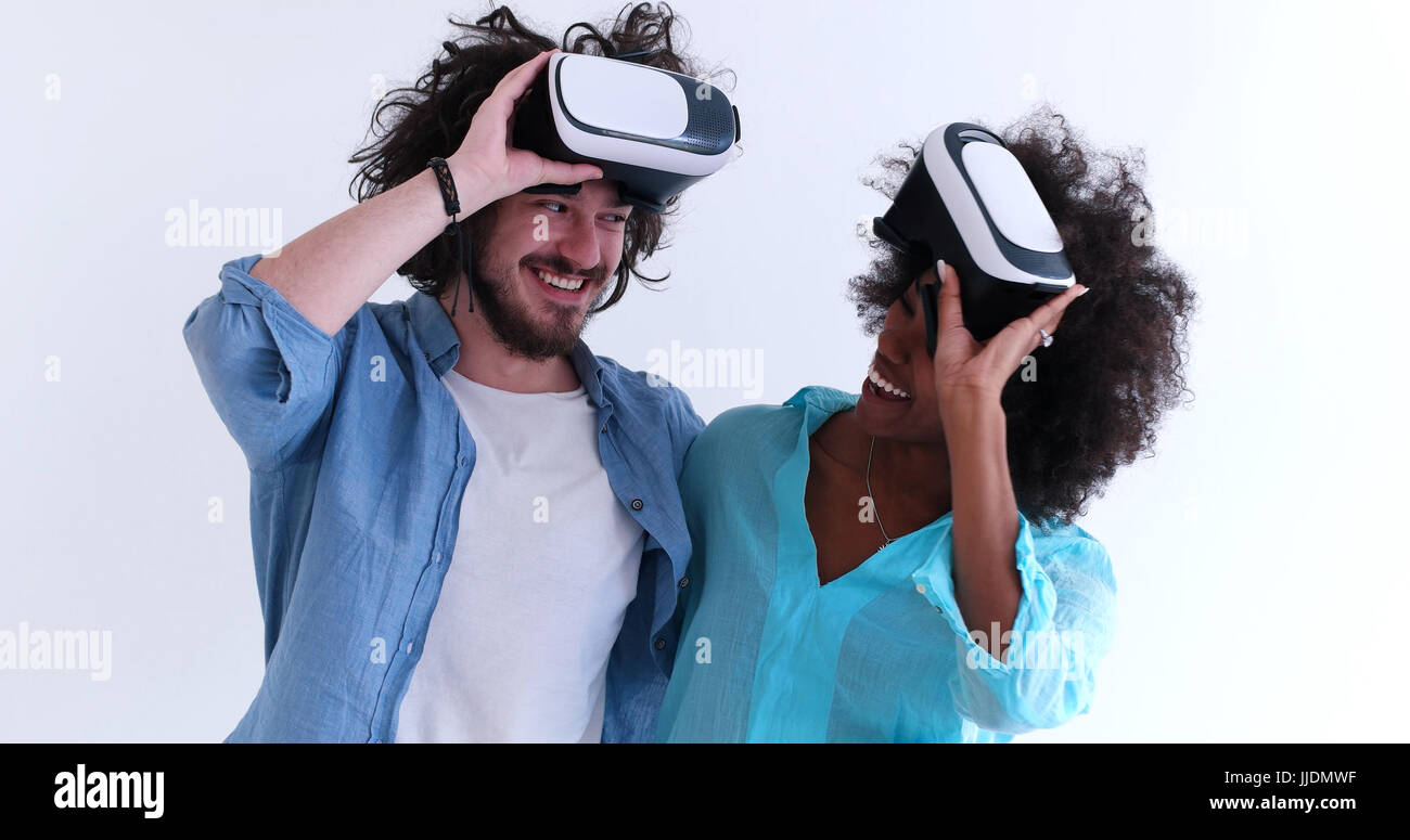 Happy multiethnic couple getting experience using VR headset glasses of ...