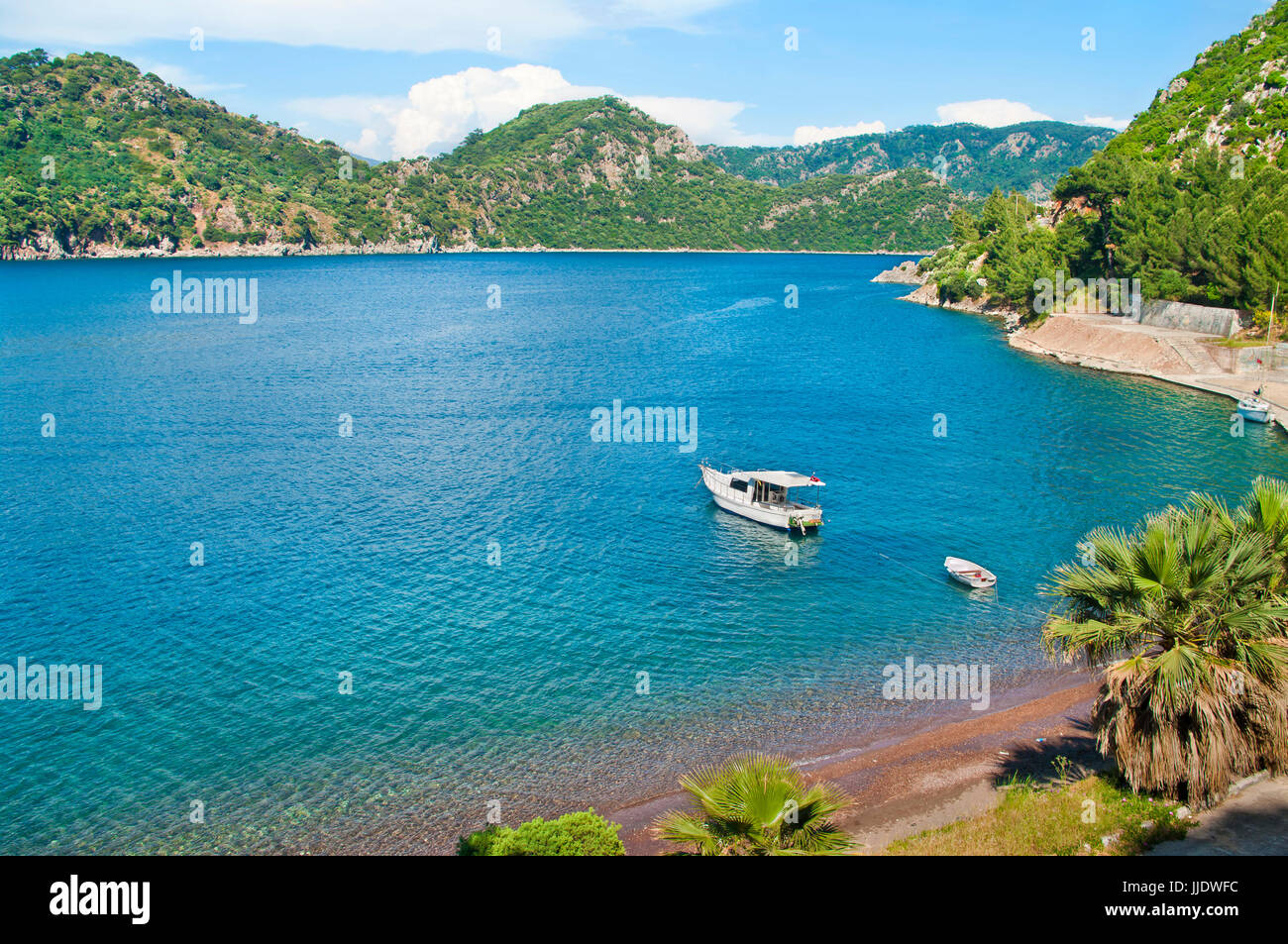 small white turkish boat anchored in sea bay near Marmaris surrounded ...