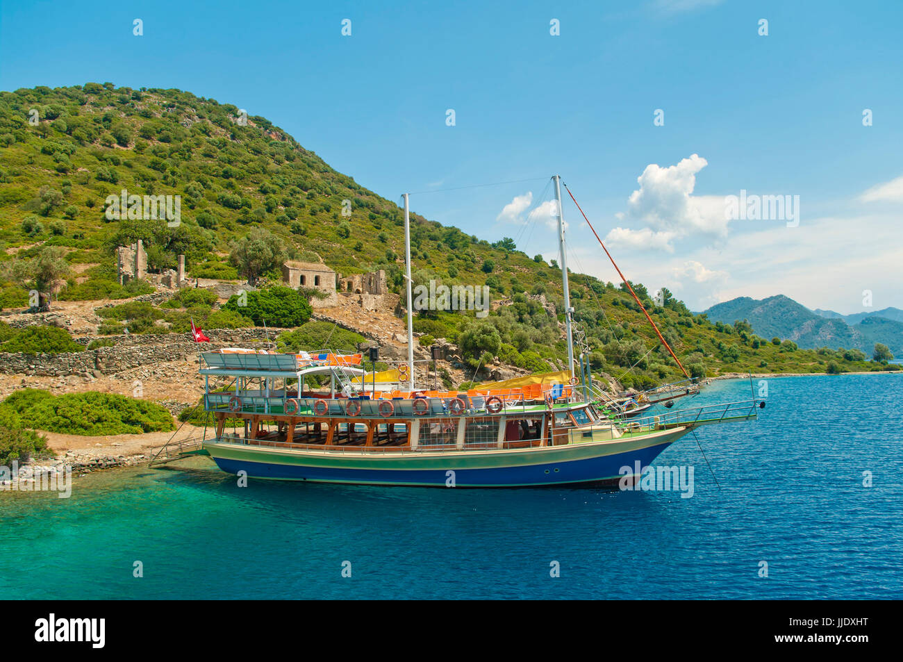 two tourist boats at Camellia island in Hisaronu bay with old byzantine ...